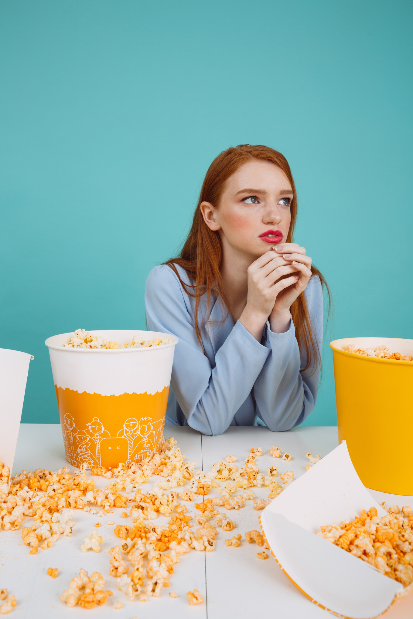 Vertical image of Pensive woman eating popcorn, a Person Photo by Dean ...