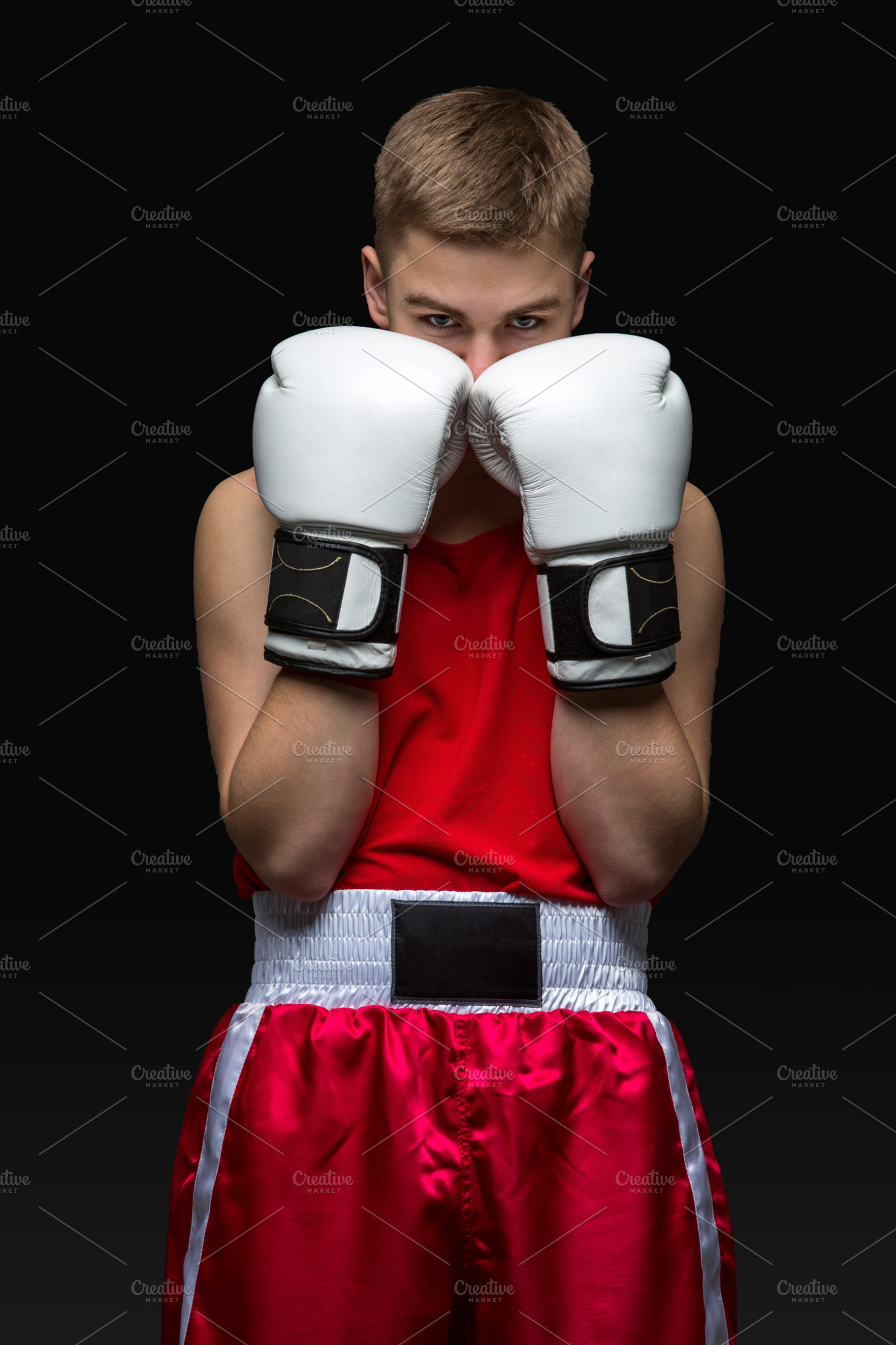 Young boxer sportsman in red sport suit featuring strength, body, and ...