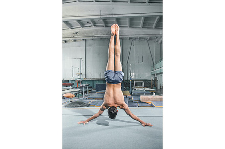 Caucasian man gymnastic acrobatics equilibrium posture at gym ...