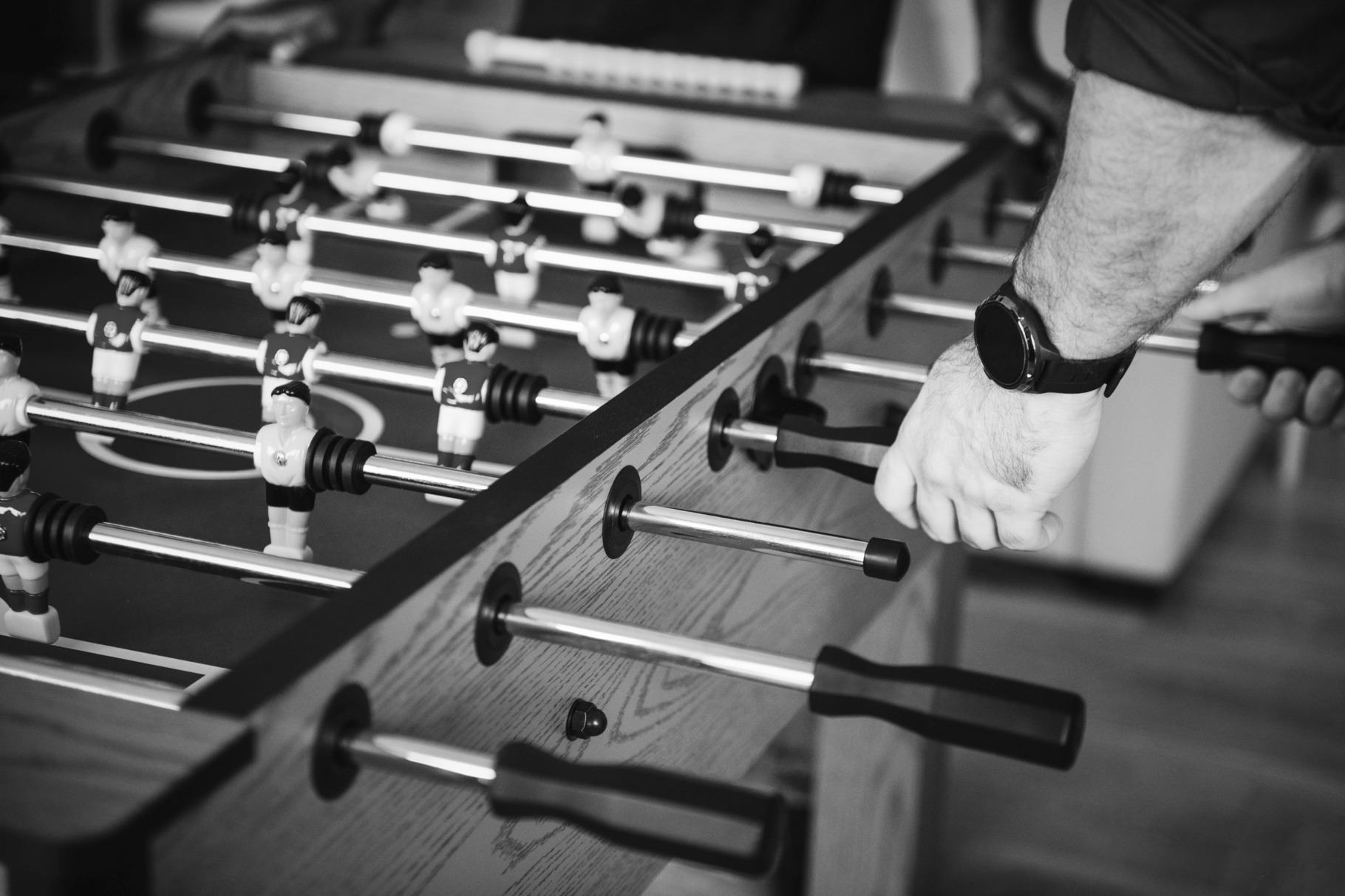 People playing table foosball, a Photo by rawpixel