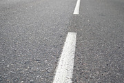 White line markings on the road.