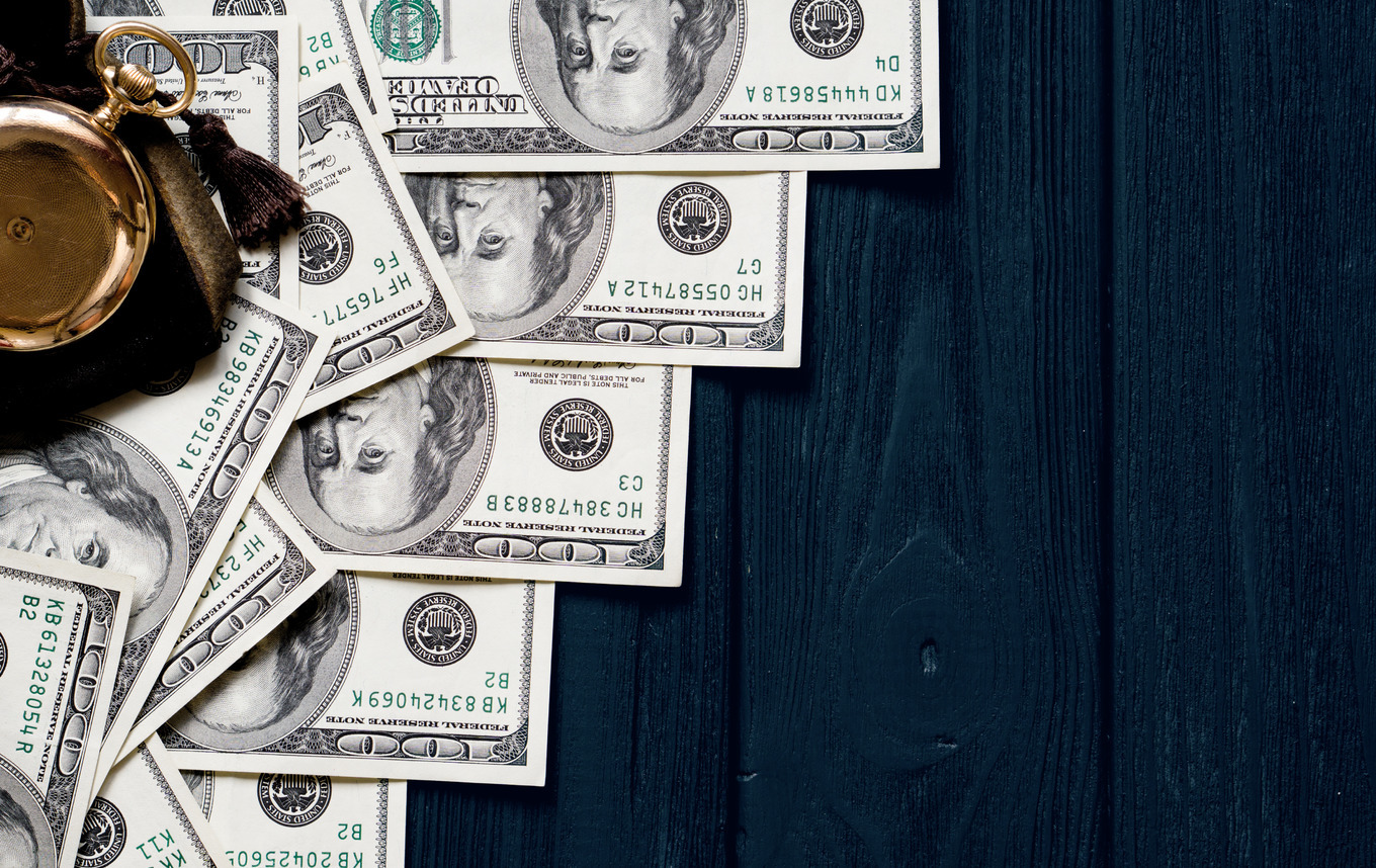 Stack of money on blue background, a Business Photo by PhotoVector