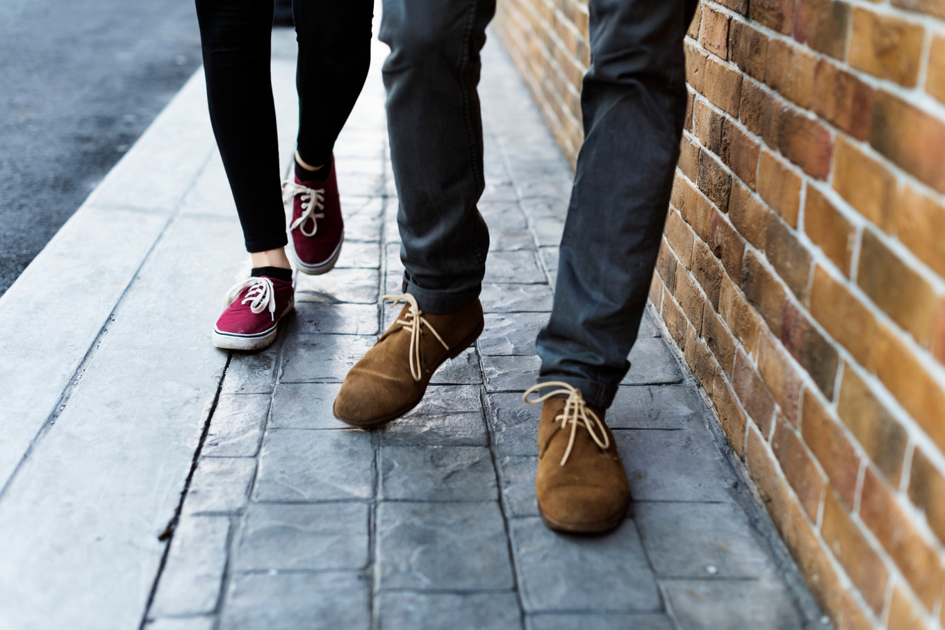 People walking together featuring fashion, brick wall, and street ...