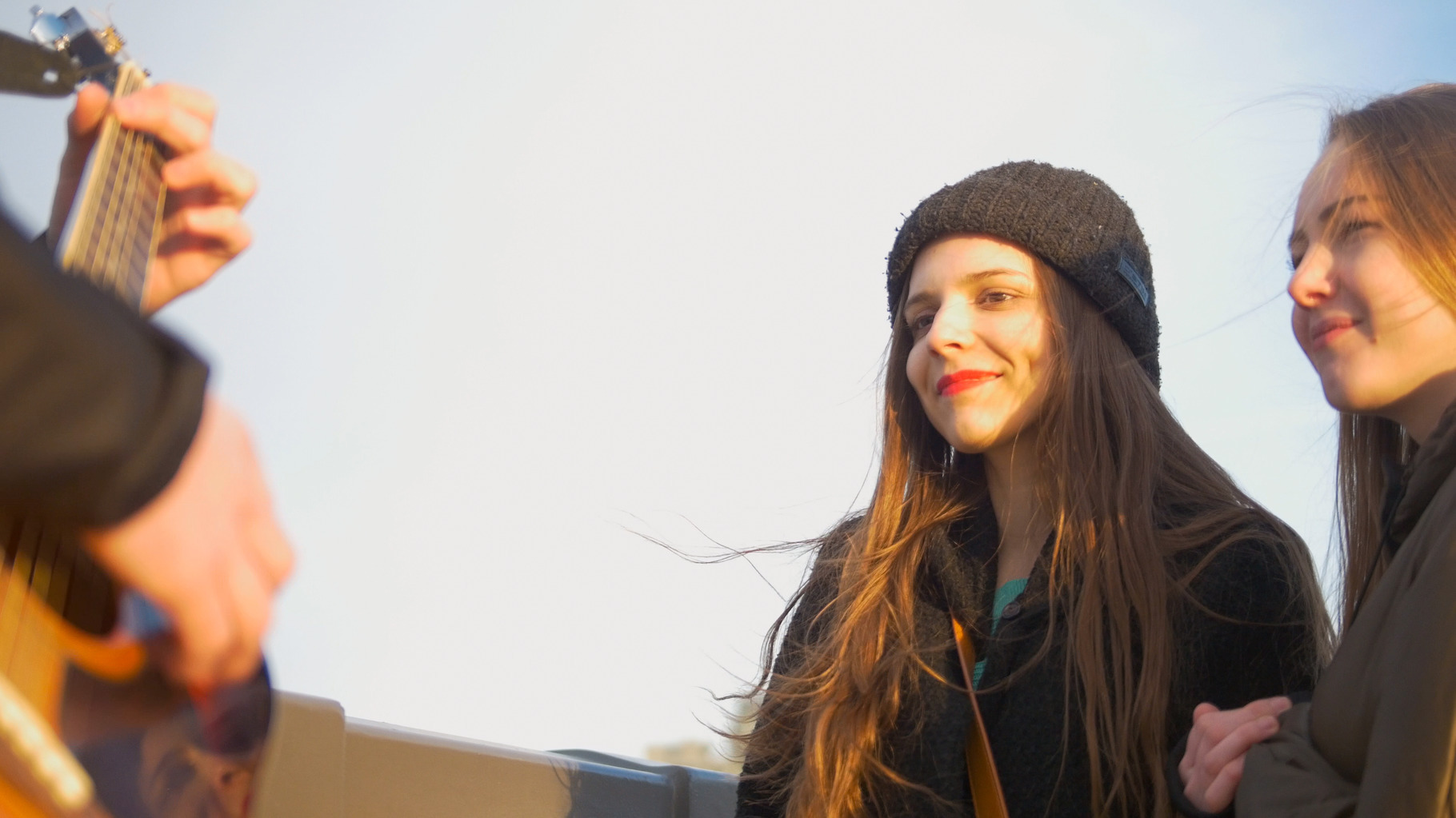 Three friends singing with the guitar at the sunset outdoors, a Photo ...