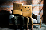 Couple wearing smilley face box featuring couple, sitting, and together ...