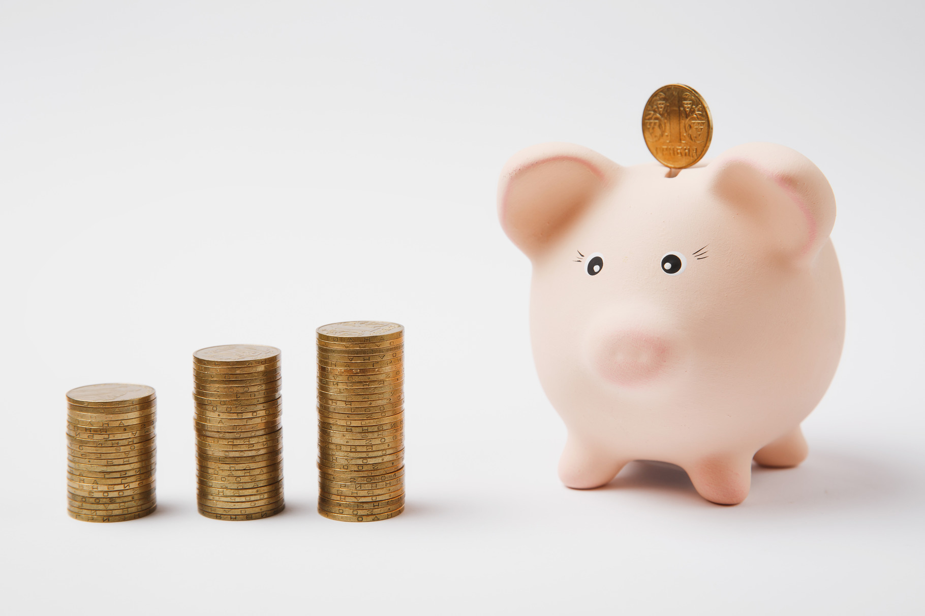 Coin falling into pink piggy money b featuring isolated, white, and ...