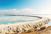 View of Dead Sea coastline with white beach made salt at sunny day in ...