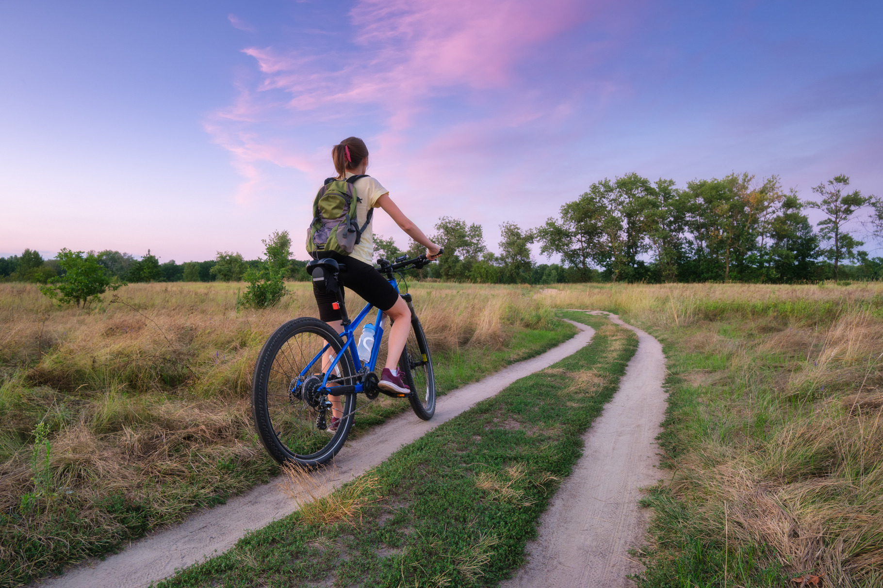Woman riding a mountain bike in cross country road in summer, a Sports ...
