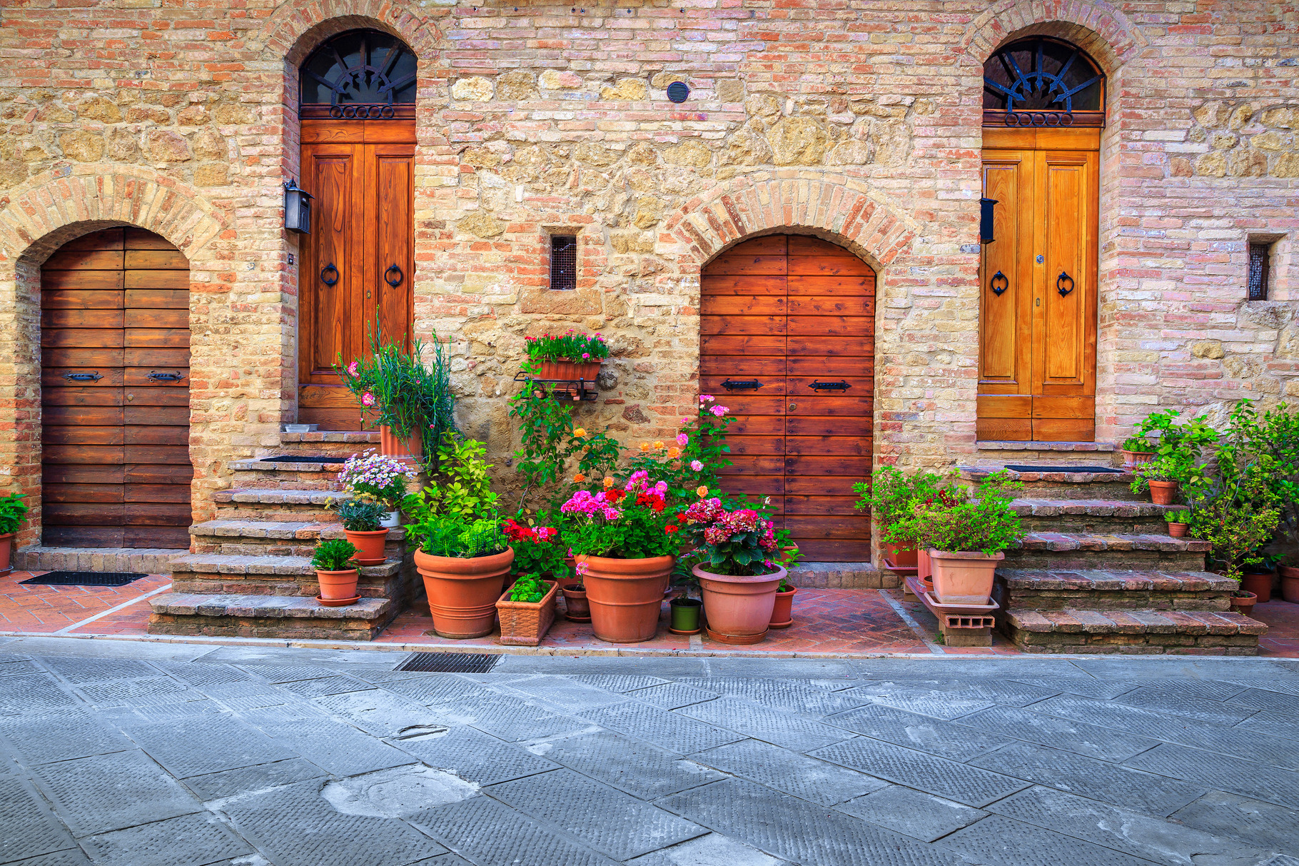 Floral entrance and wooden doors, an Architecture Photo by Alpine Dreams