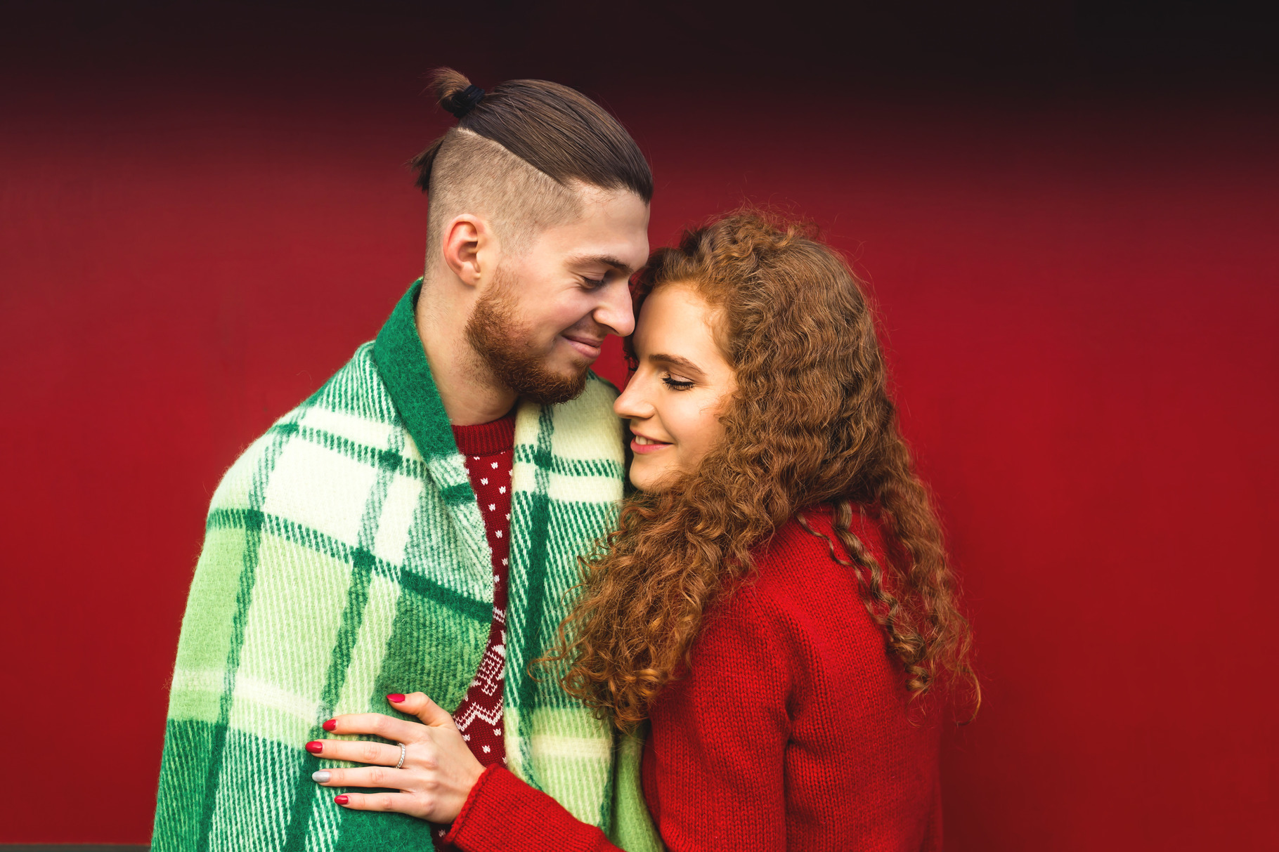 Lovers hug and smile happily on red | People Images ~ Creative Market