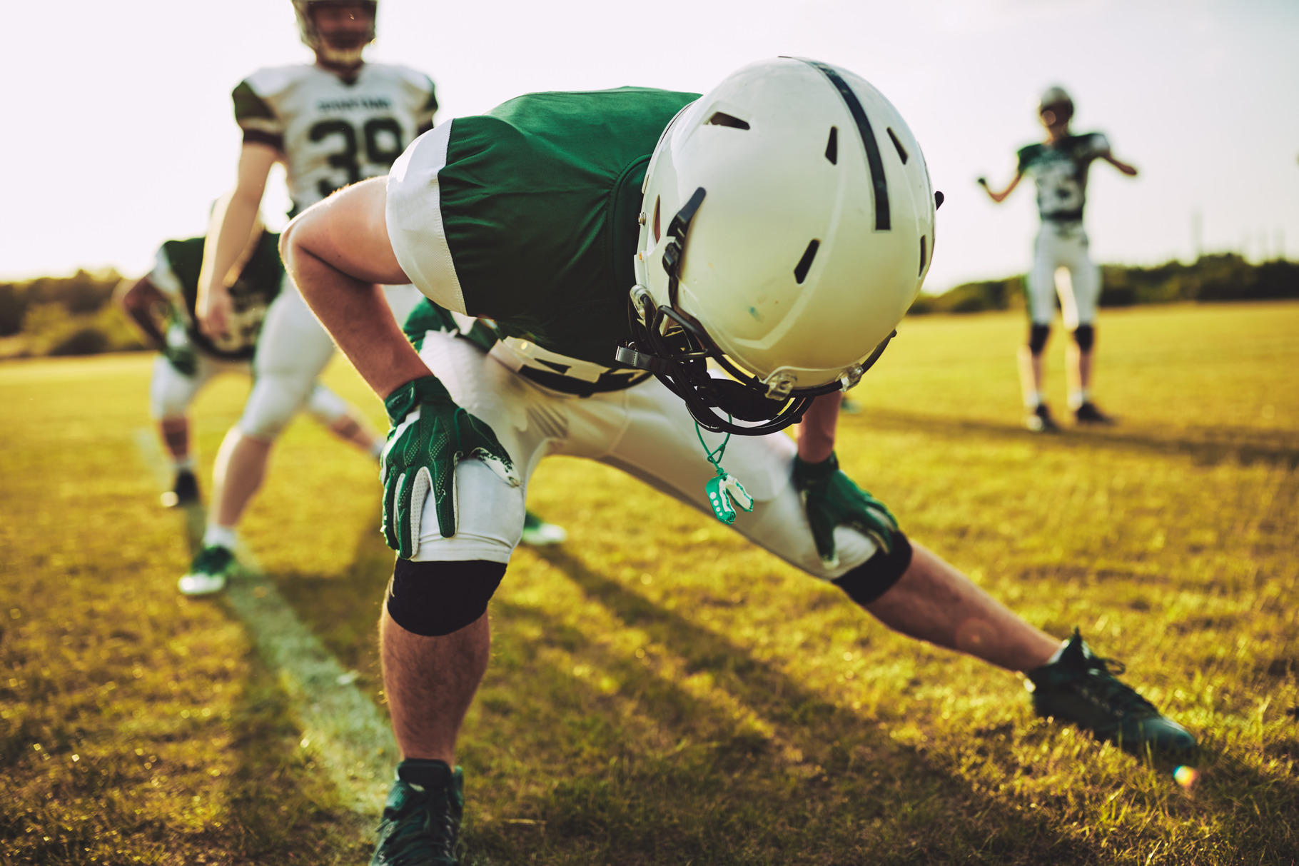 American football players stretching, a Sports & Recreation Photo by ...