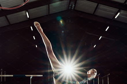 Young woman gymnast doing stretching leg in a studio, a Photo by ...