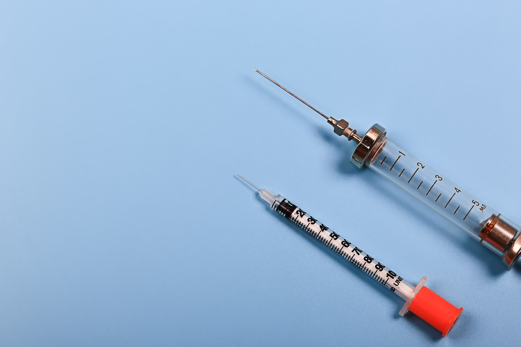 Medical concept. Two syringes for injections on a blue background ...