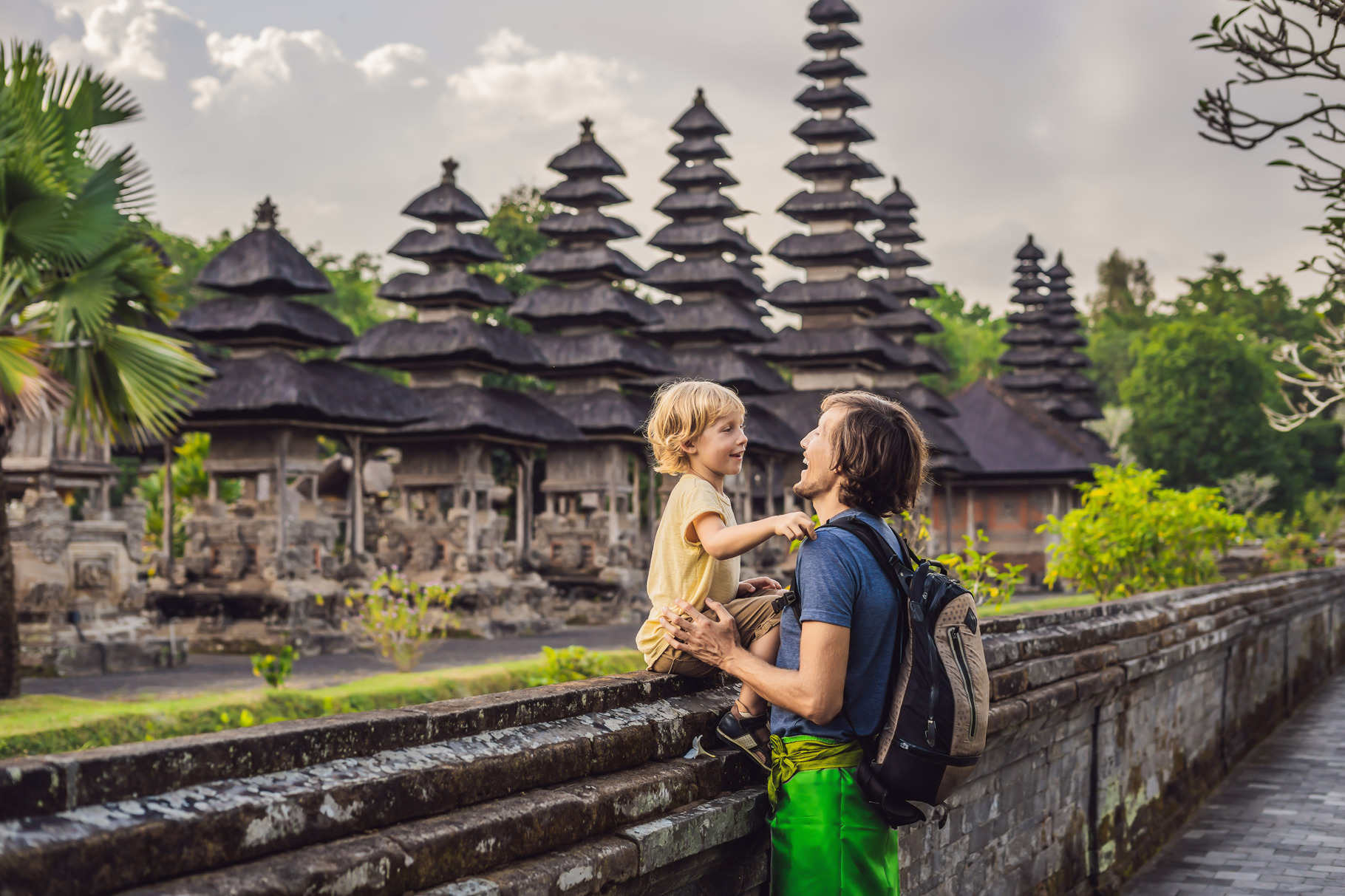 Dad and son tourists in traditional containing bali, indonesia, and ...