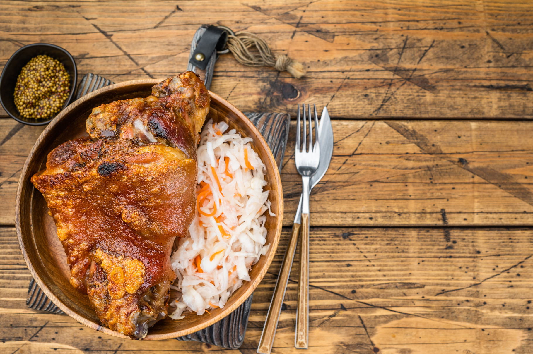 Crispy roasted pork knuckle shank with golden crackling rind ser, a ...