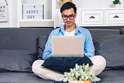 Young smiling asian man using laptop computer working and video, a ...