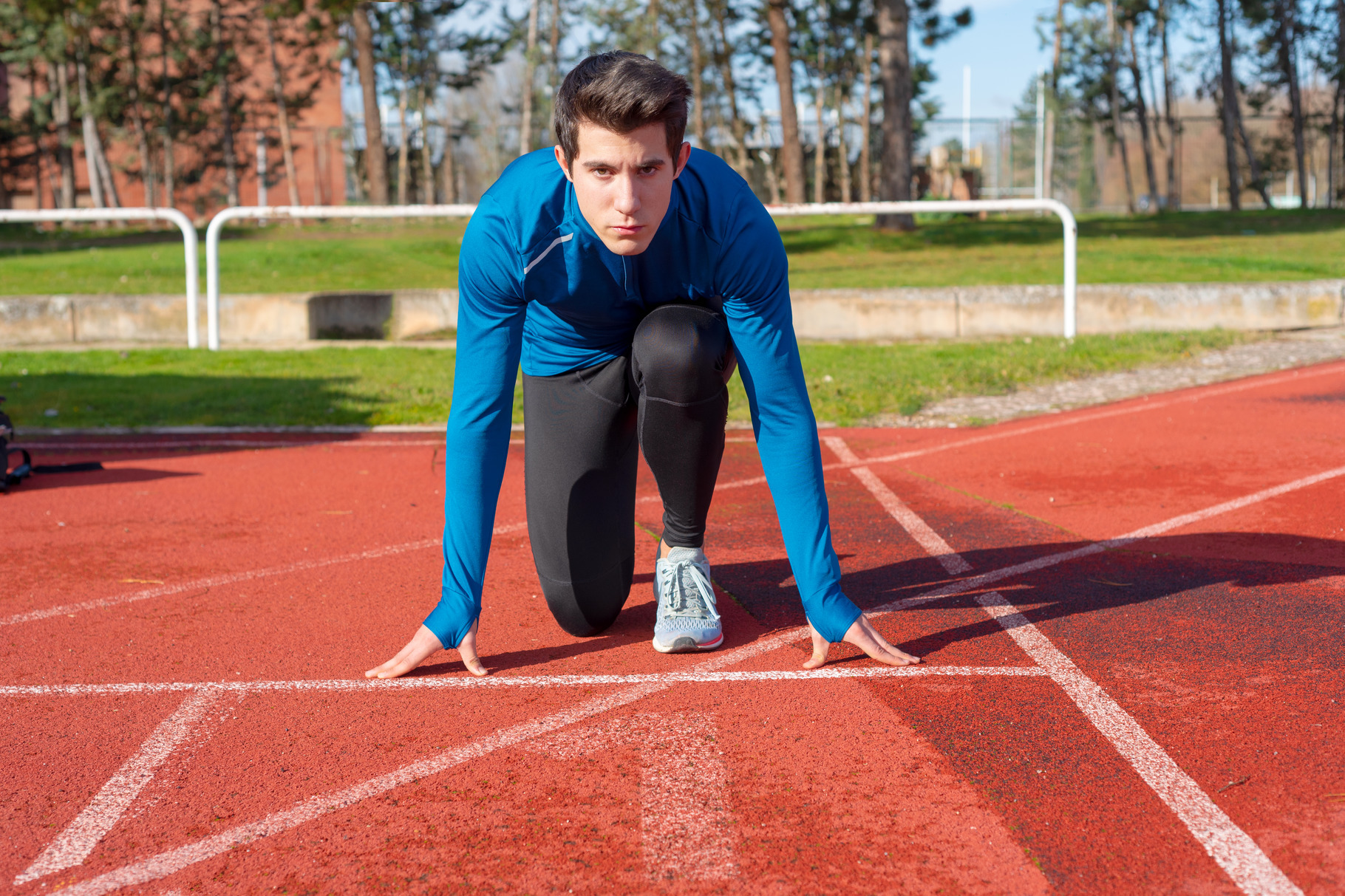 Man athlete on the starting line of featuring athletic, line, and track ...
