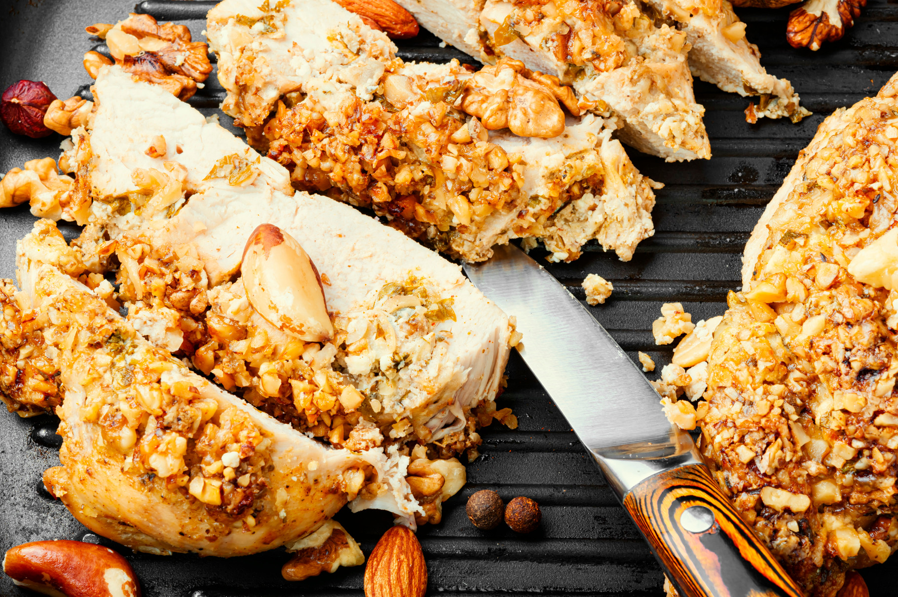 Stuffed chicken breast with nuts containing chicken, nut, and meat, a ...