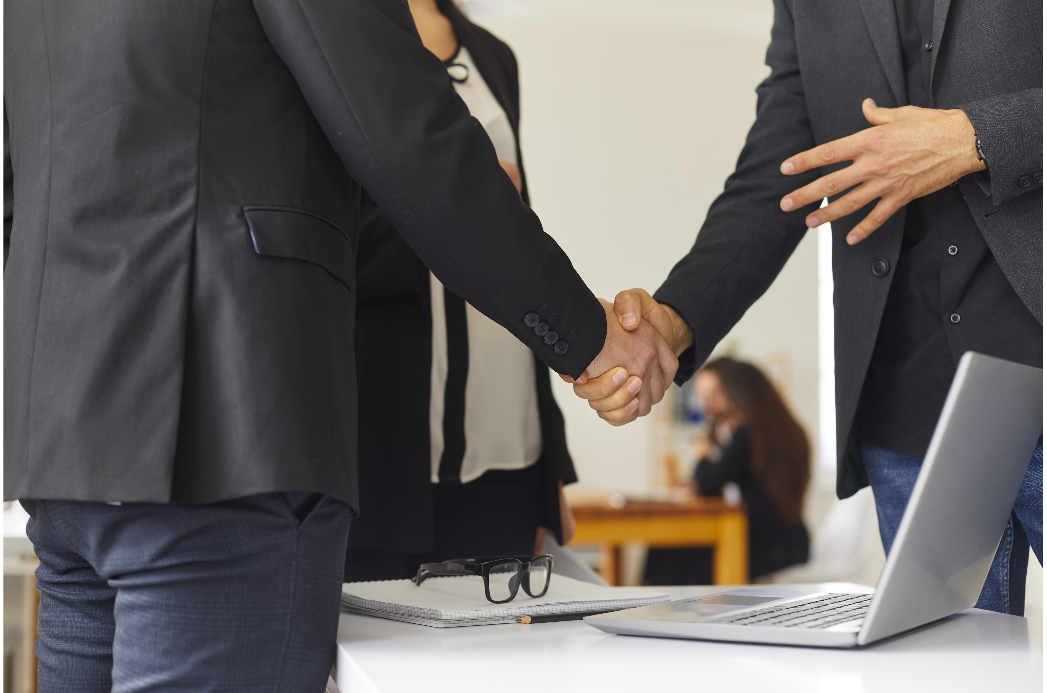 Closeup of people shaking hands, a Business Photo by StudioRomantic