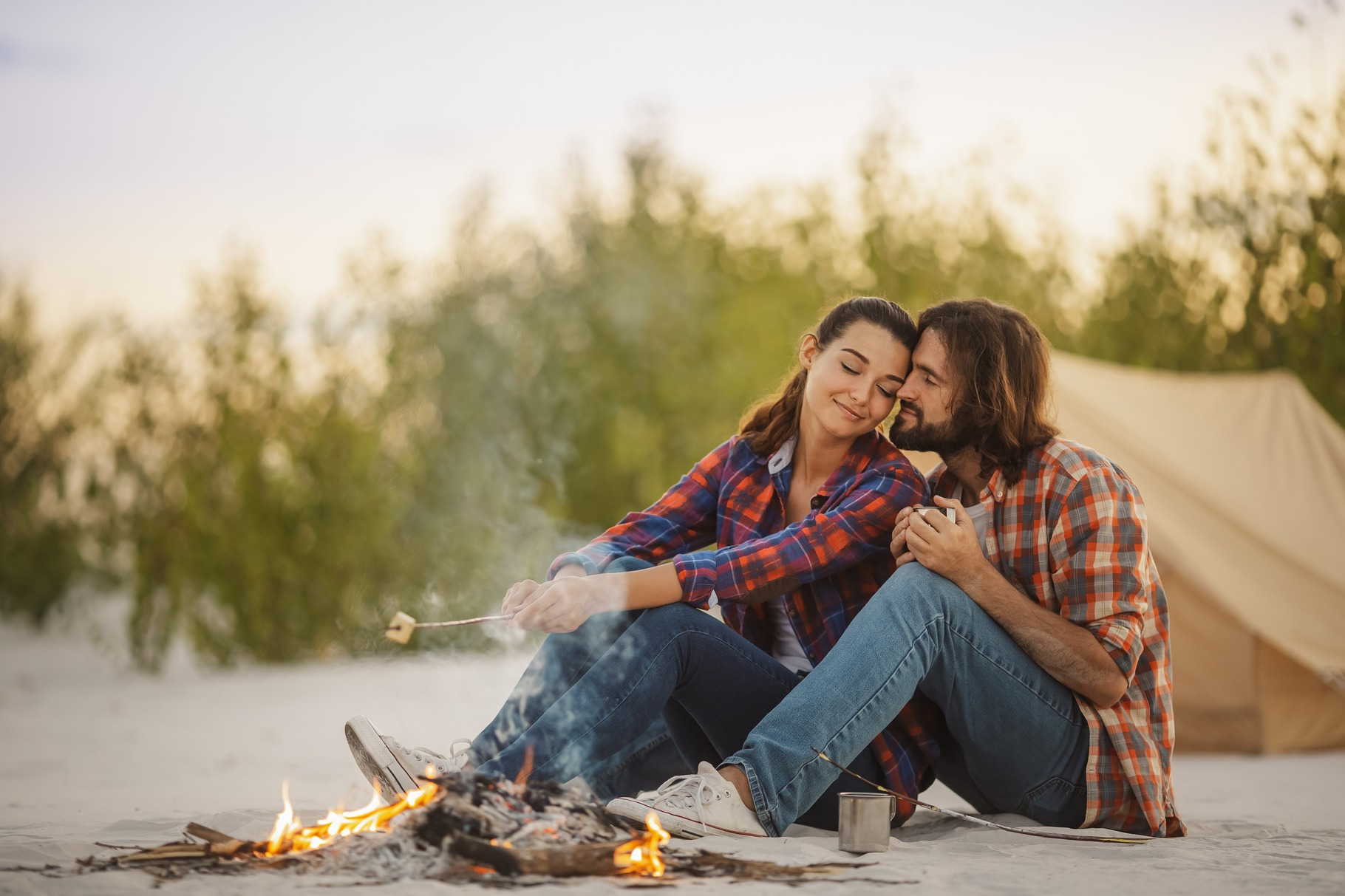 Couple camping near campfire featuring love, couple, and campfire, a ...