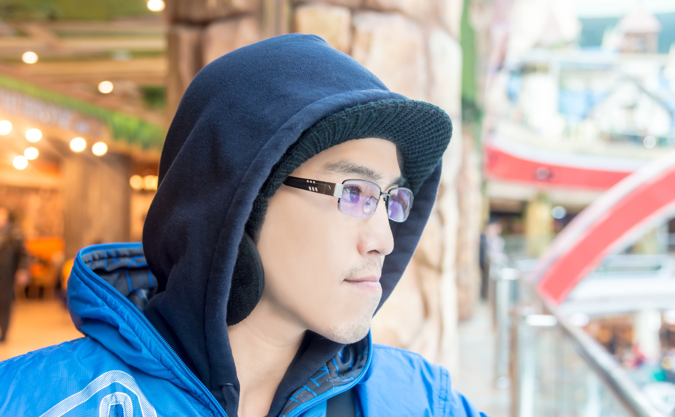 Asian man in blue hood in city, a Person Photo by PeoGeo Studio