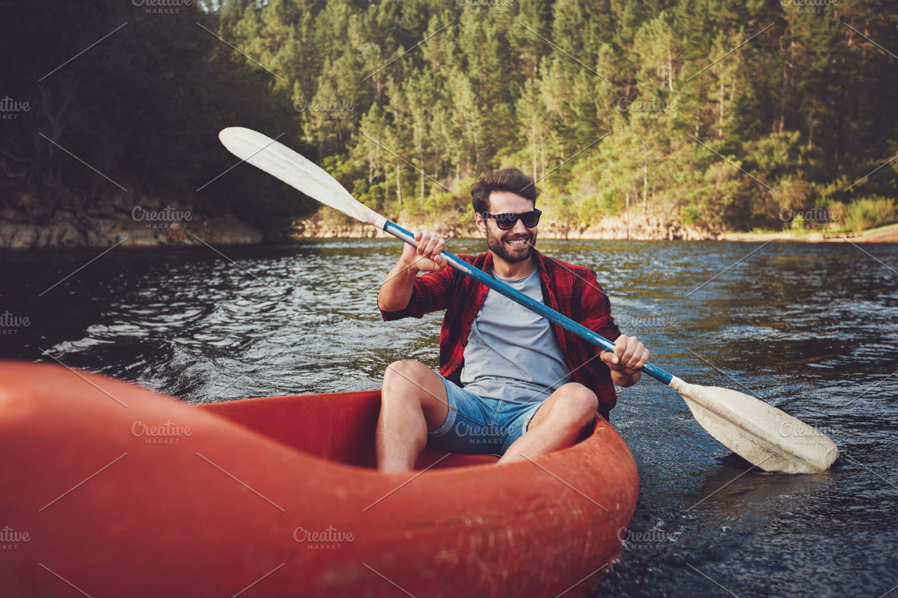 Young man kayaking on a lake, a Person Photo by Jacob Lund