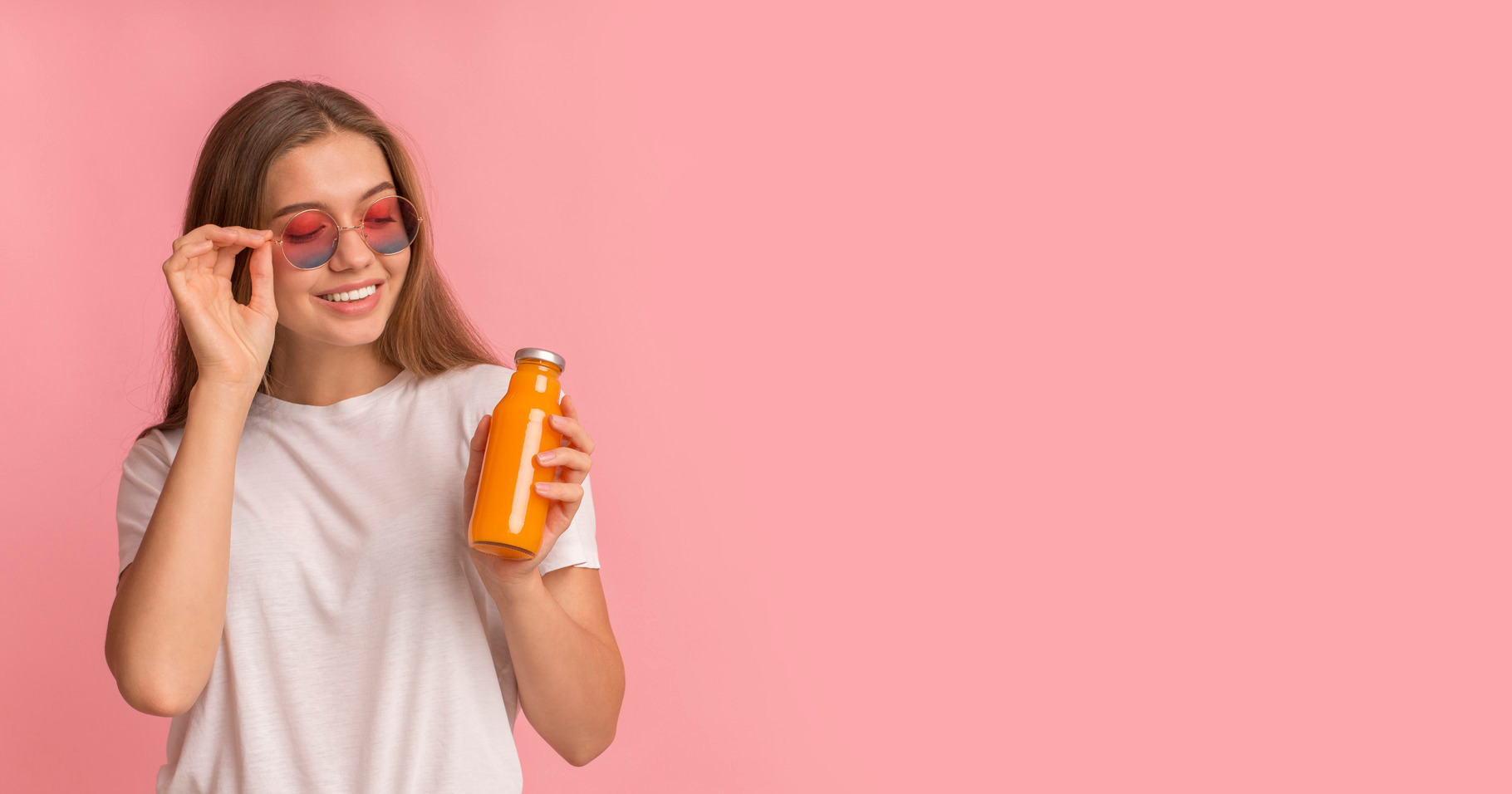 Cool girl holds glass bottle with or, a Background Photo by Prostock-Studio