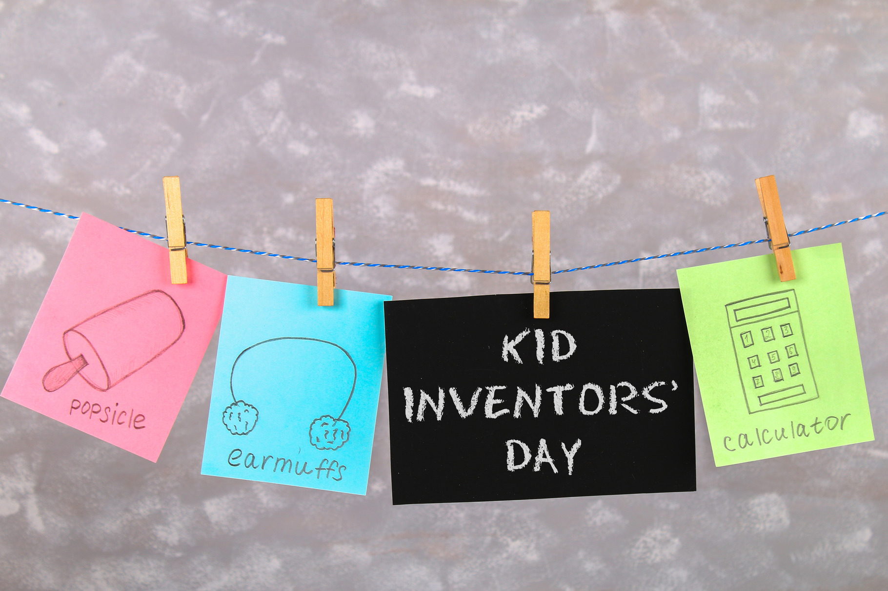 Notes hang on clothes pegs with drawings of children's inventions ...