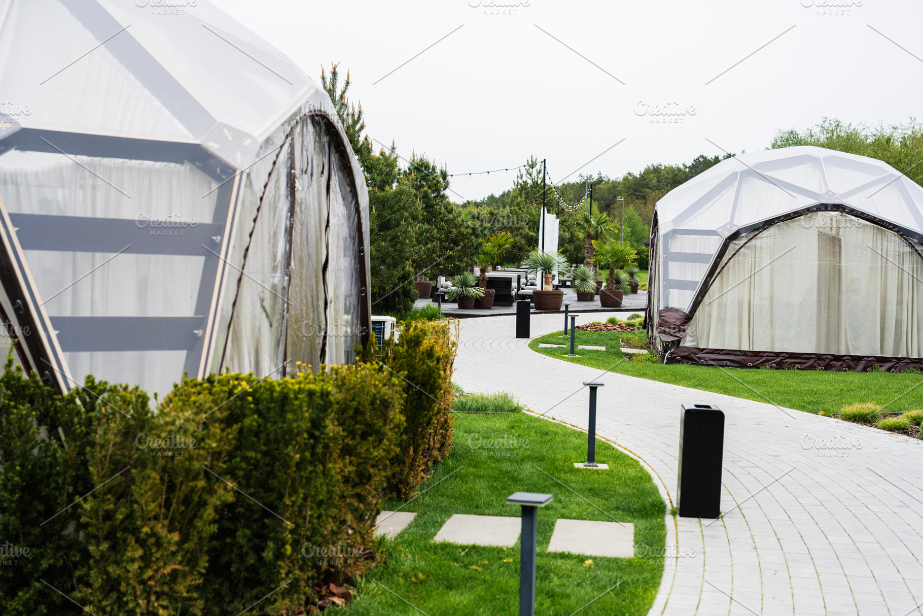 Modern outdoor patio with geodesic domes and landscaped greenery ...