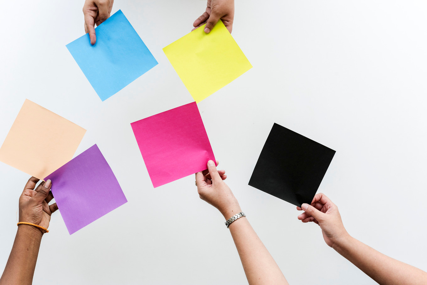 Diverse hands holding colorful stock photo containing copy space and ...