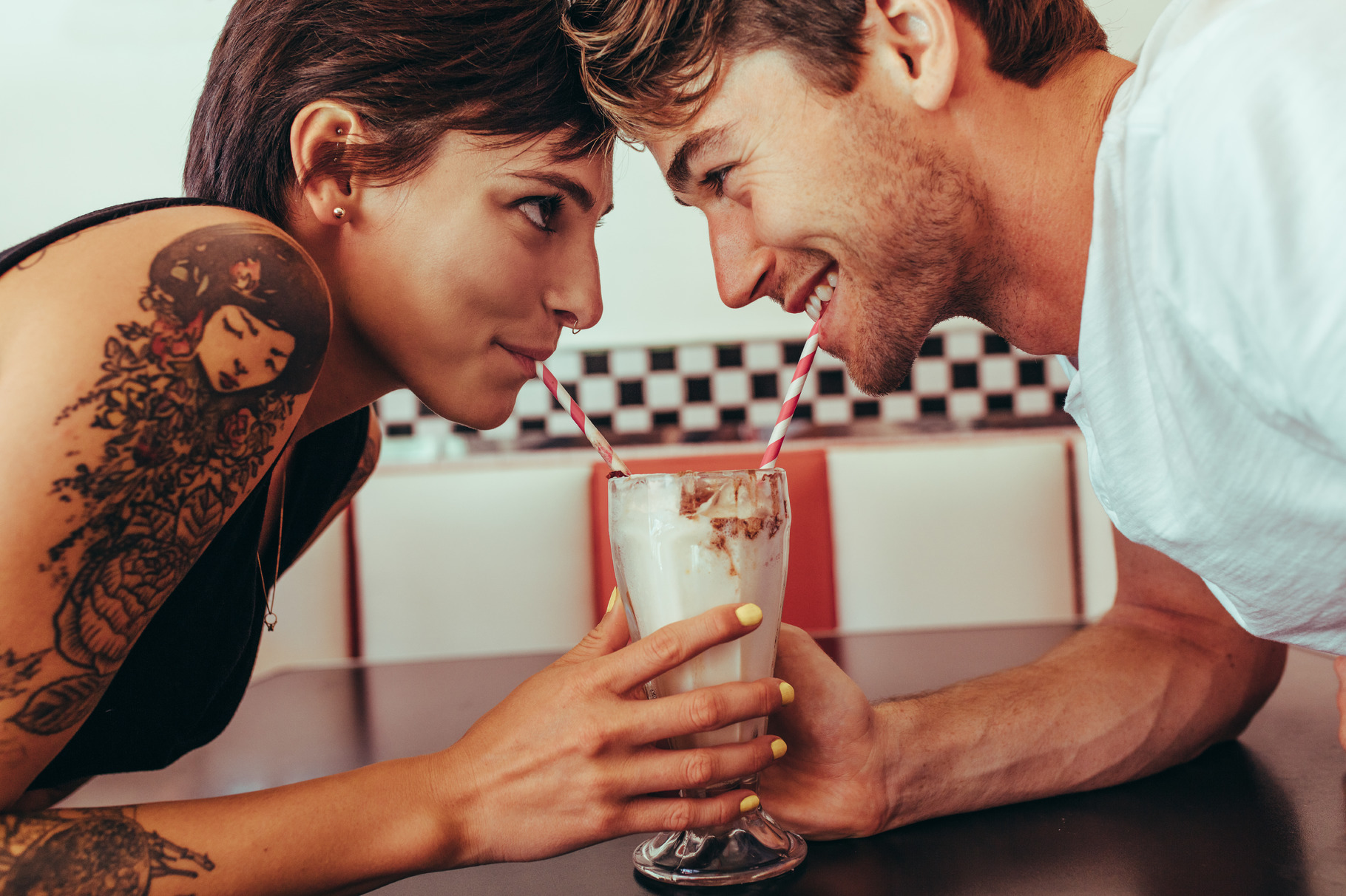 Romantic couple sharing milk shake, a Person Photo by Jacob Lund