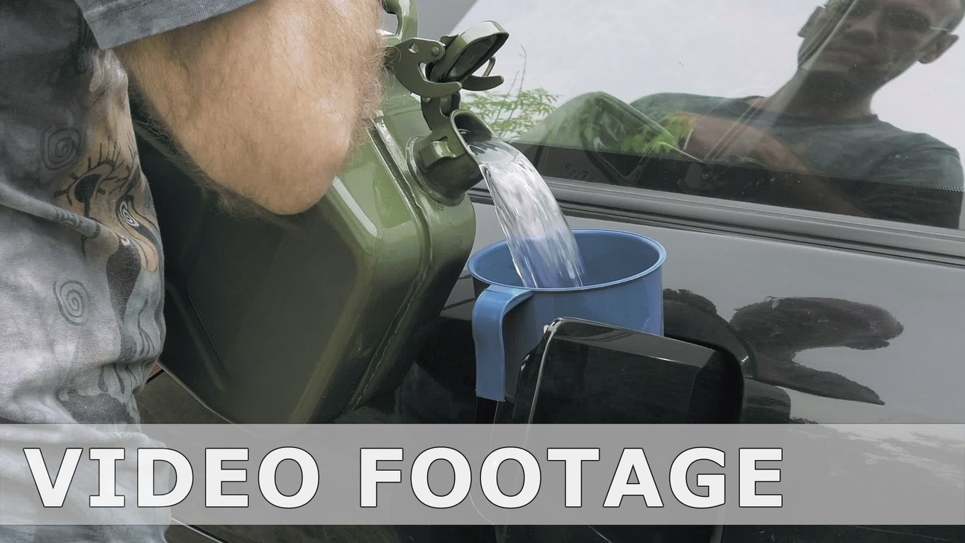 Man fuels car from jerry can petrol gas or diesel, a Graphic by HighRes ...