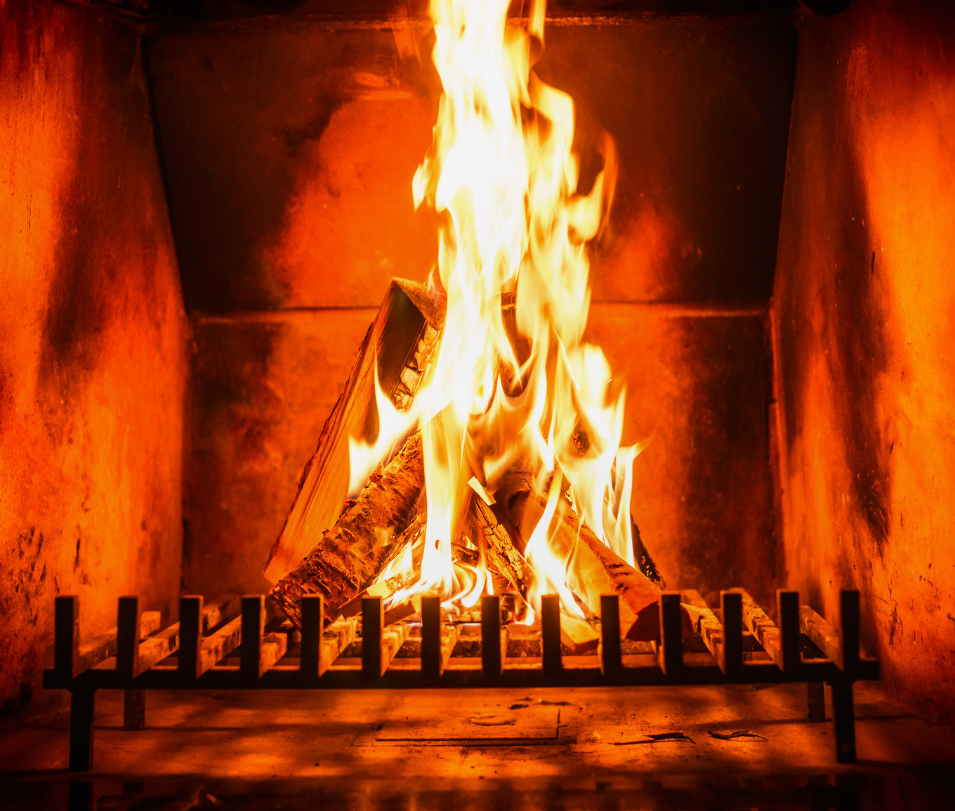 Fire burns in a fireplace featuring fireplace, fire, and old, an ...