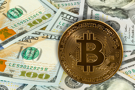 Bitcoin on top of US dollar bills or notes on table, a Business Photo ...