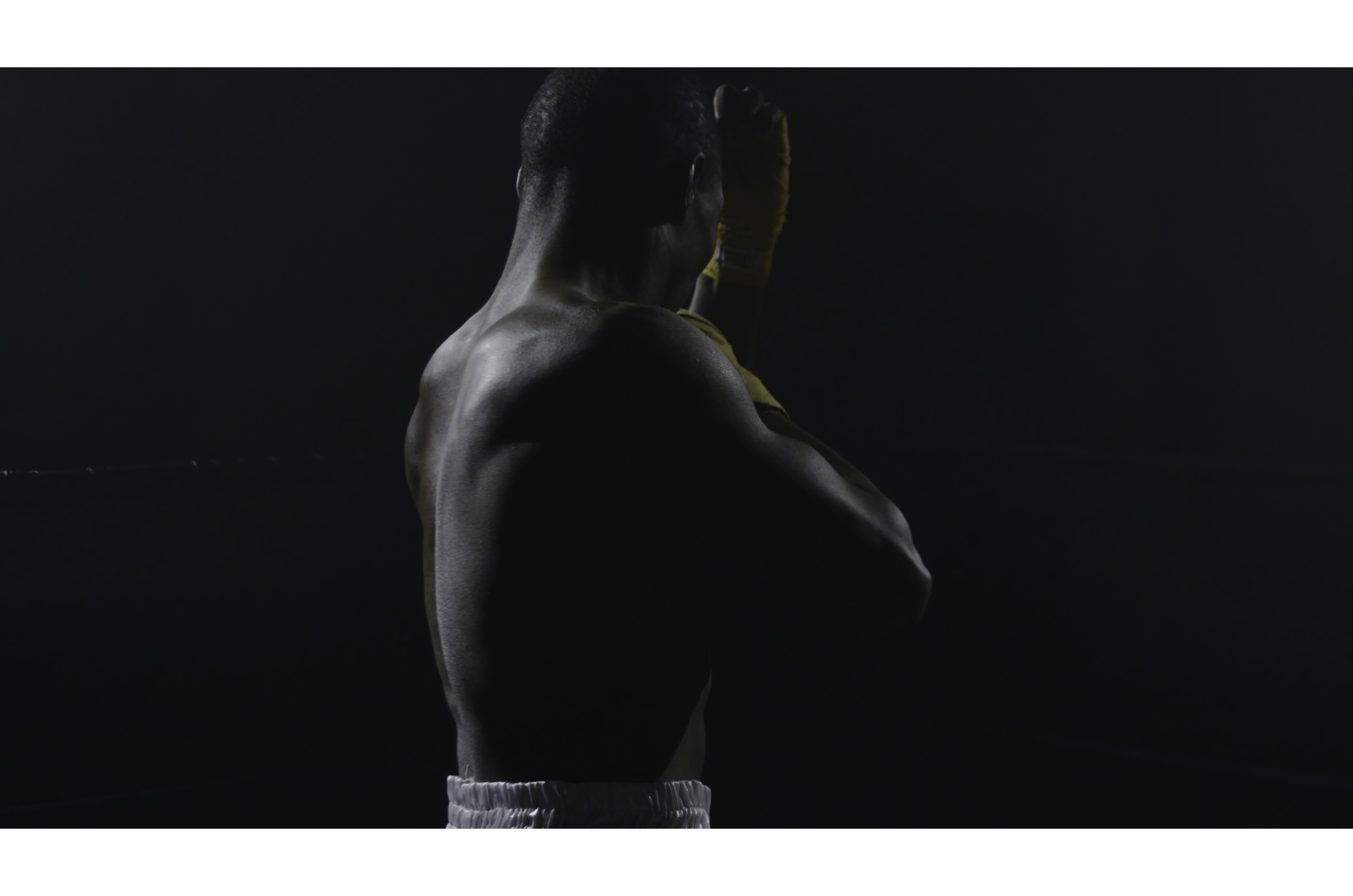 Rear view of muscular man boxing on, a Background Graphic by Media ...