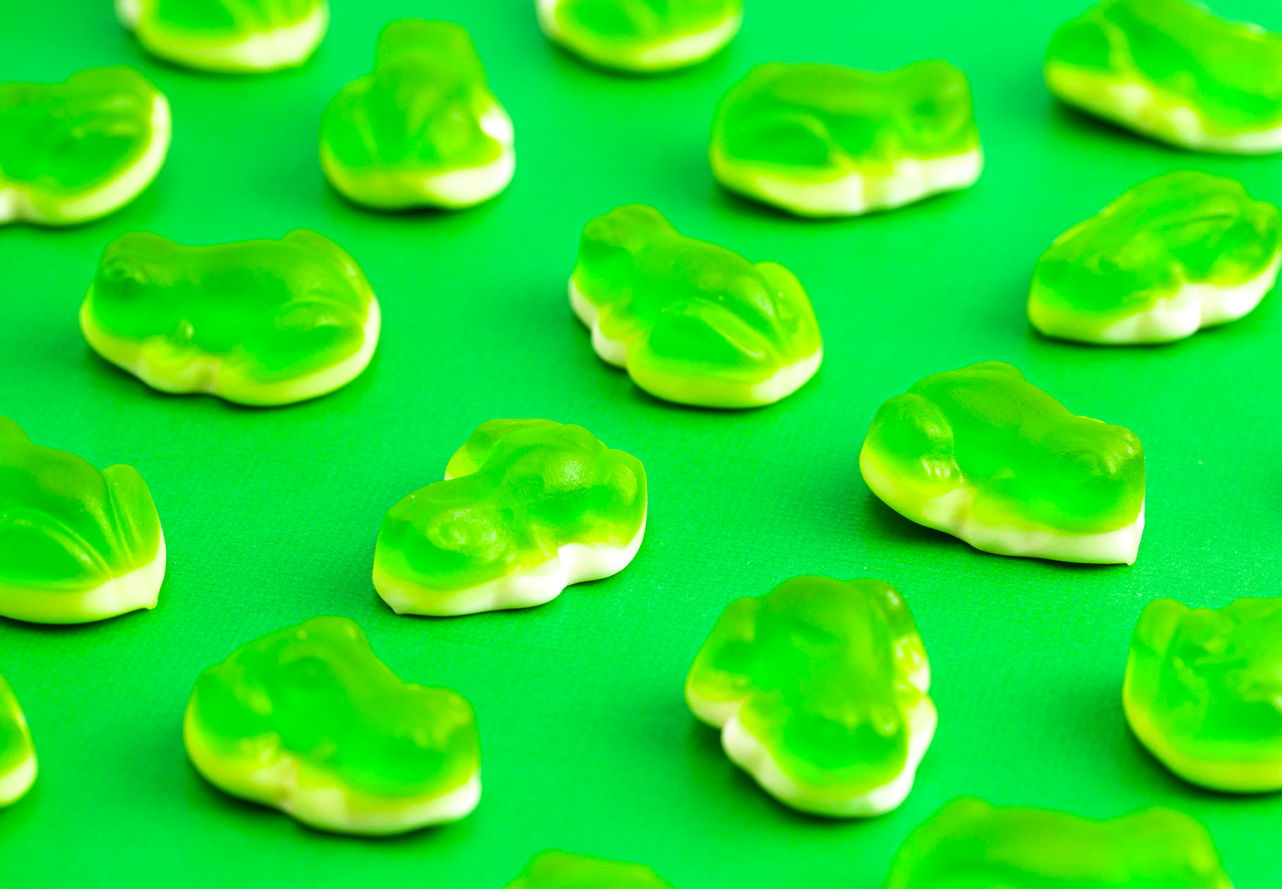 Background of Gummy Green Frogs with a Mashmallow Candy Bottom L, a ...
