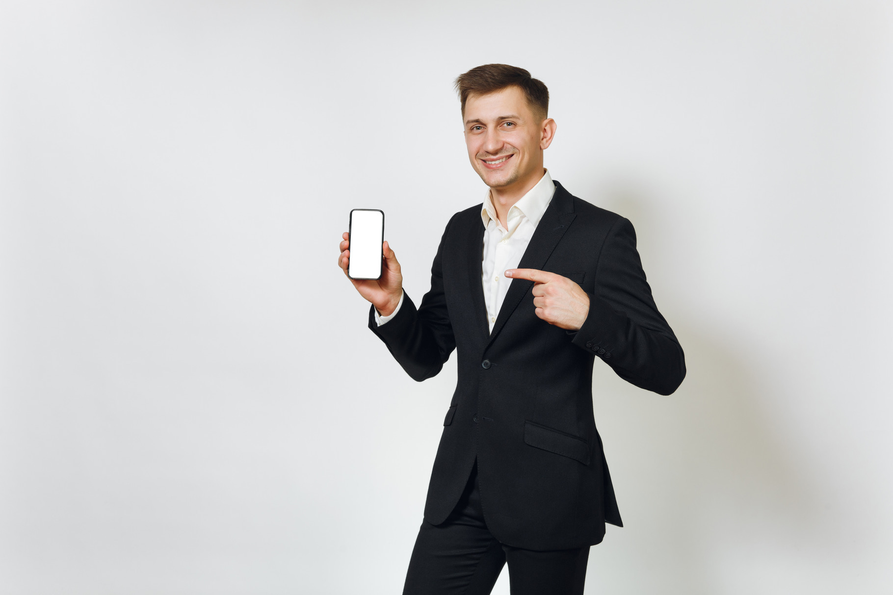 Young successful handsome rich business man in black suit pointing at ...