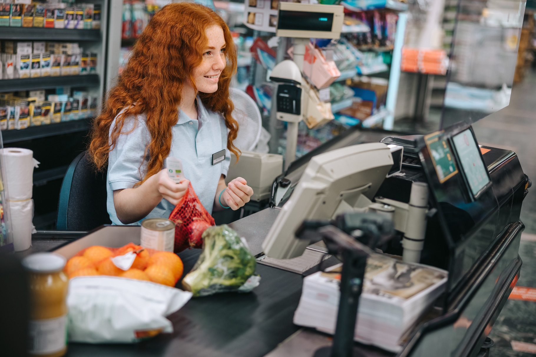 Cashier scanning grocery products at checkout, a Person Photo by Jacob Lund