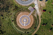 Aerial view of winding road and heliport for emergencies., a ...
