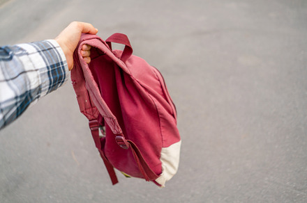 hand with a red backpack on a hikin, a Photo by Mikee's stuff