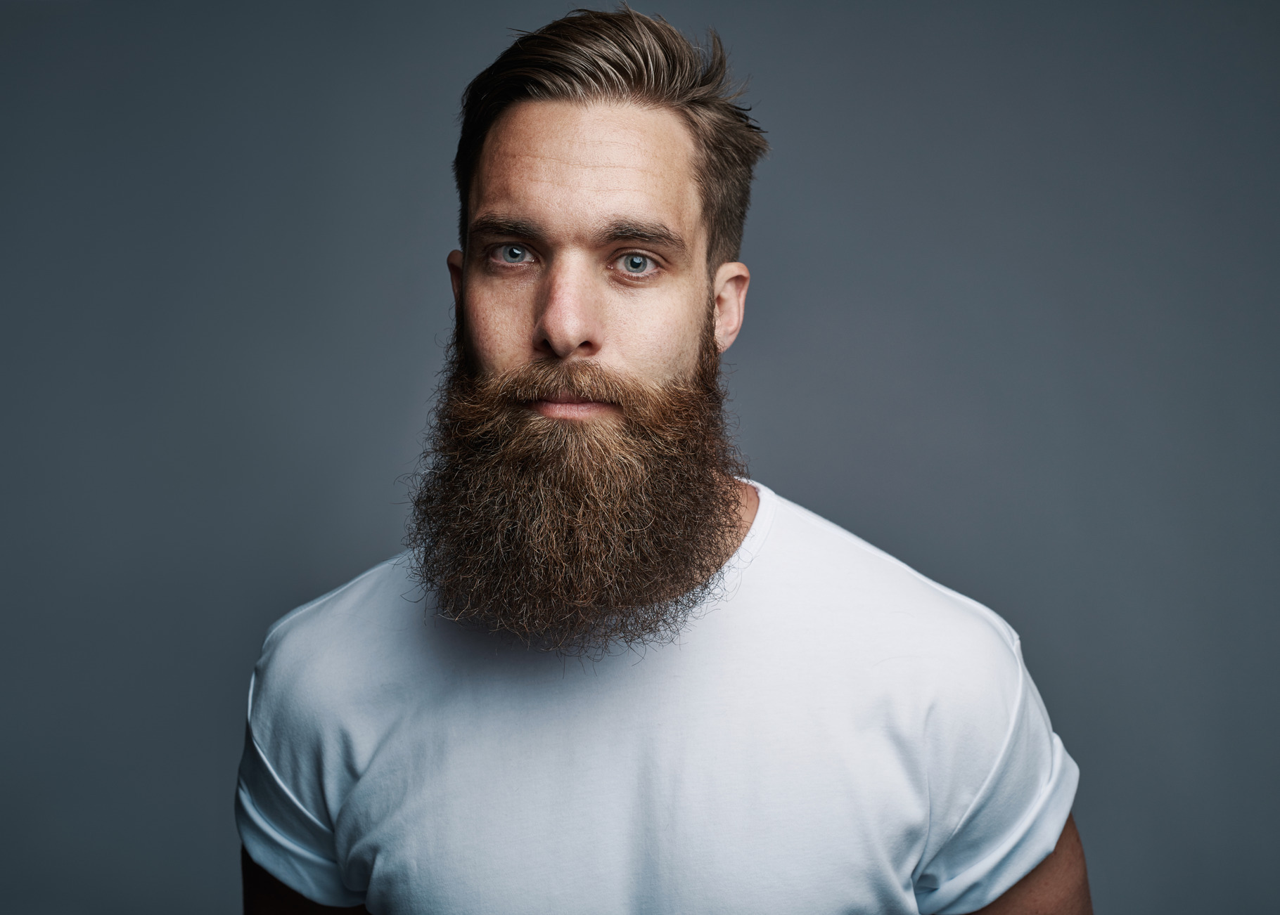 Bearded young man standing confident, a Person Photo by Stefan & Janni