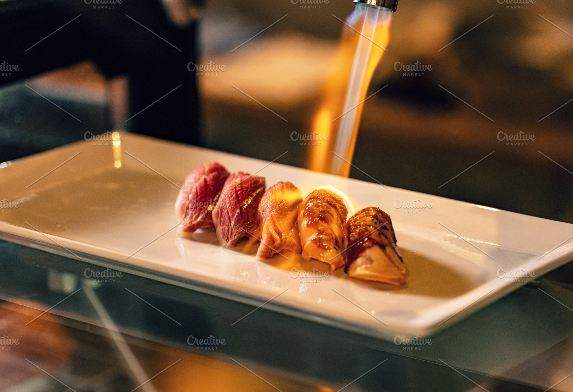 Chef using kitchen torch burn on salmon sushi, a Photo by Grafvision ...