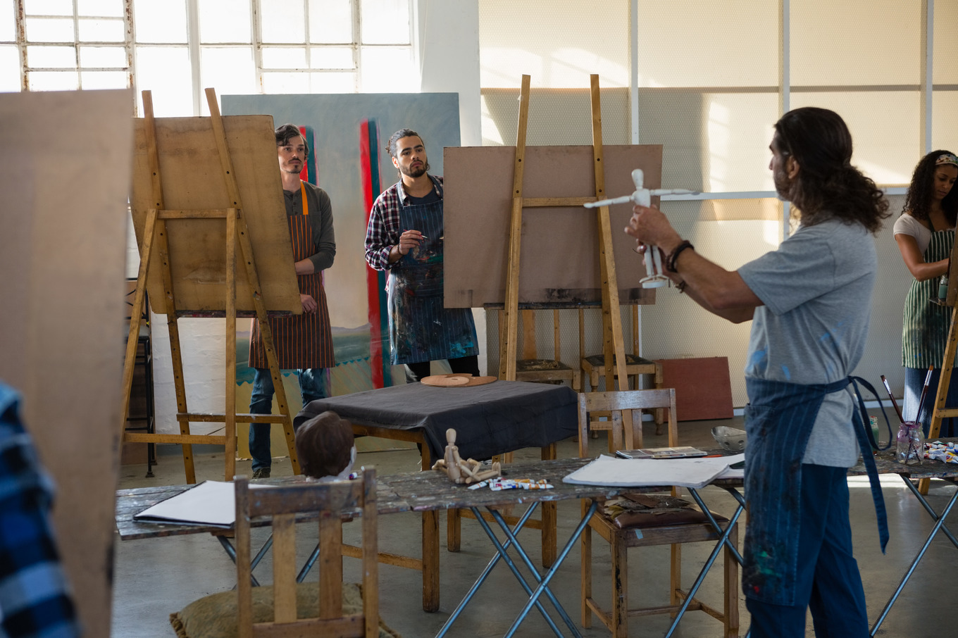Artists looking at man showing sculpture, a Photo by WavebreakPremium ...