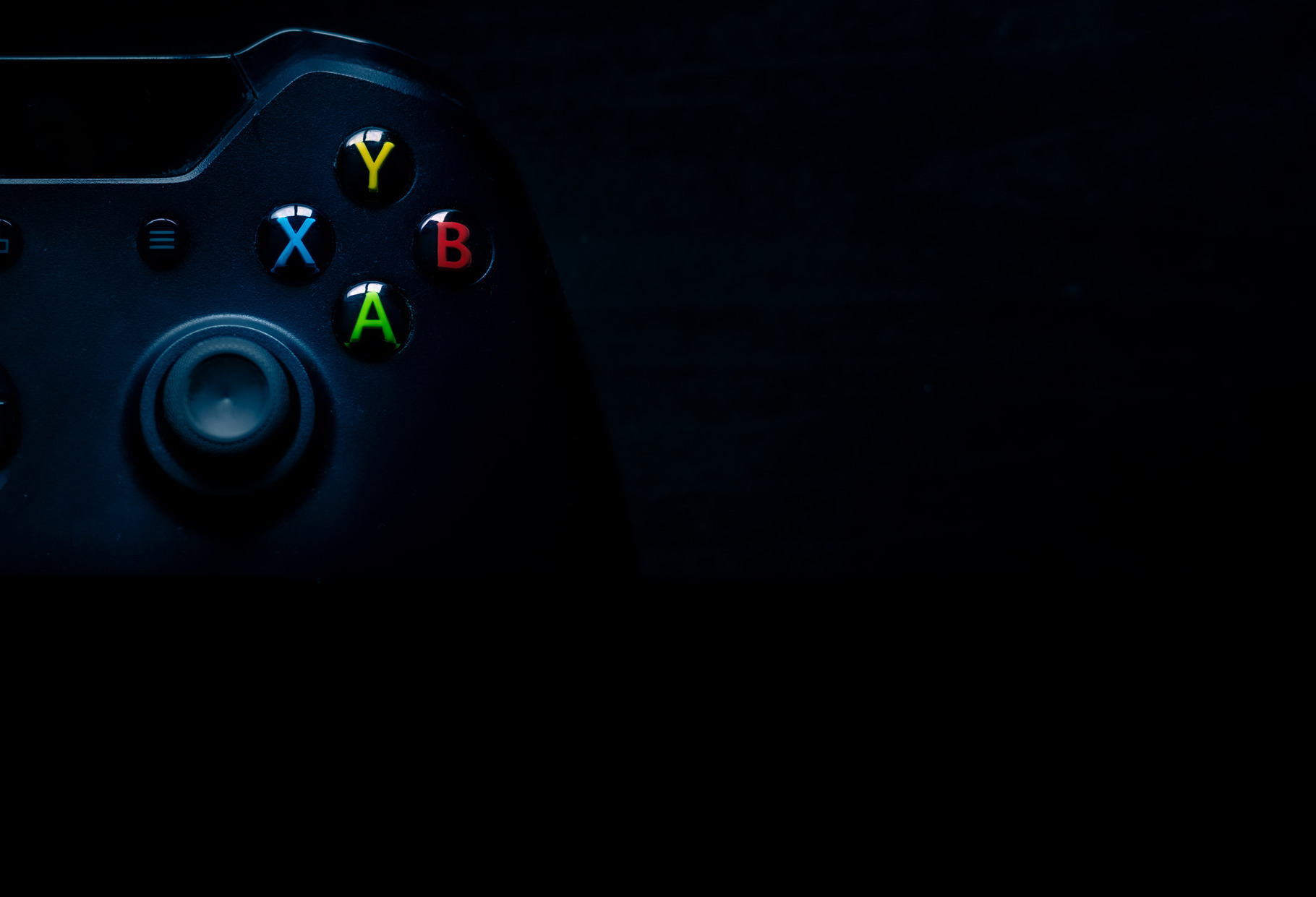 Brandless gaming controller sits in, a Technology Photo by Piranhi