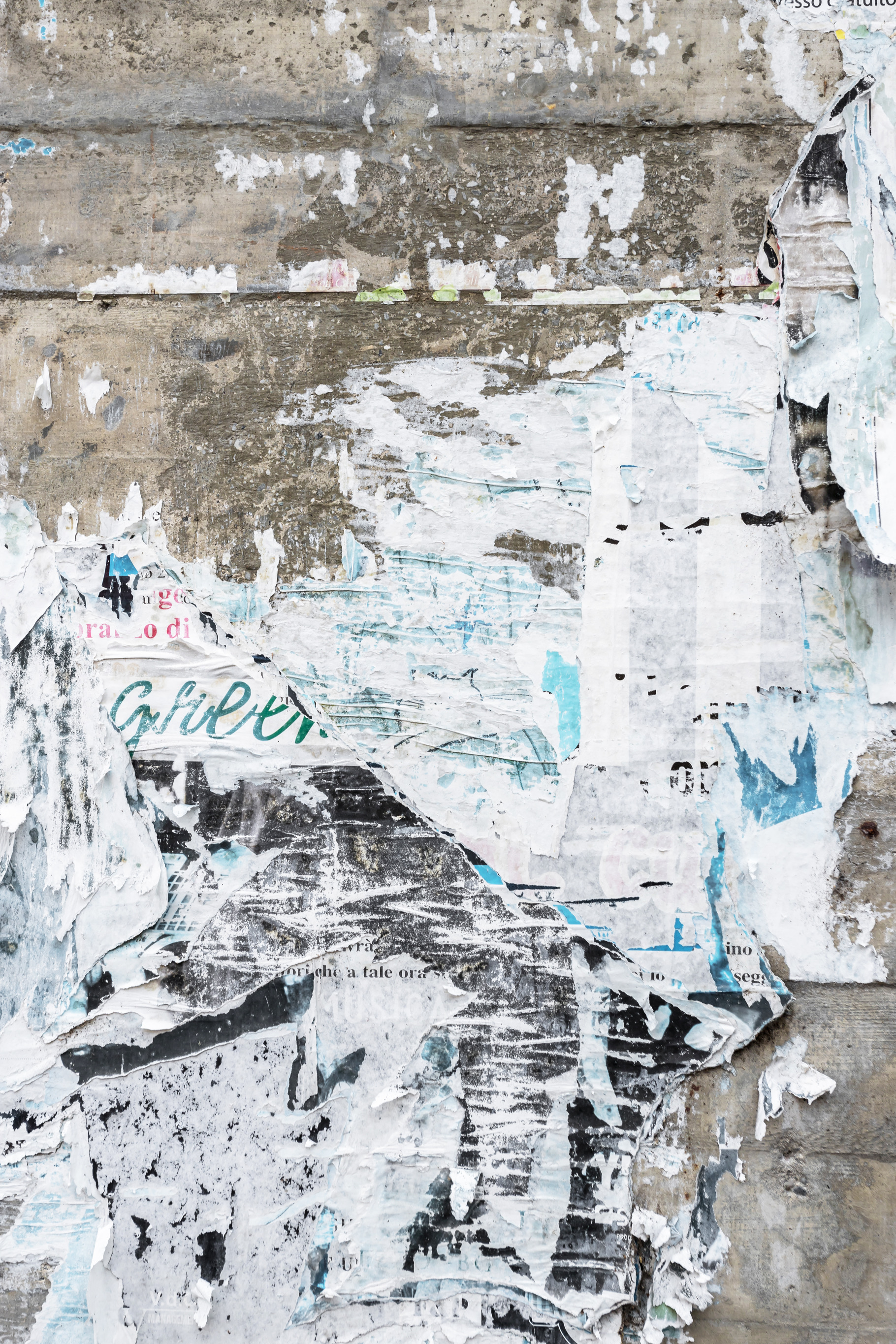 Wall with ripped posters, a Wallpaper Photo by KYNA STUDIO