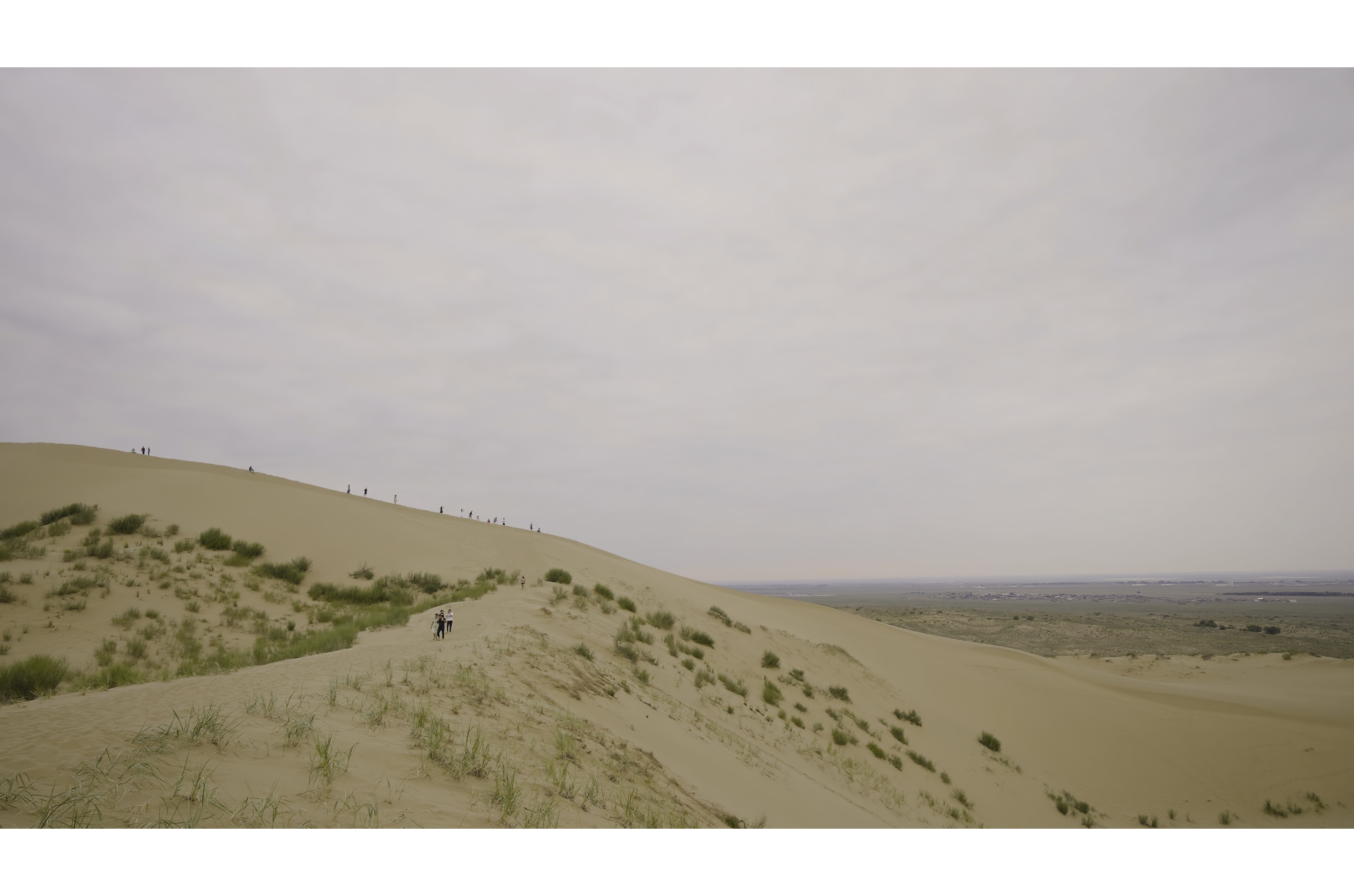 People walk along sandy ridge | Nature Stock Photos ~ Creative Market