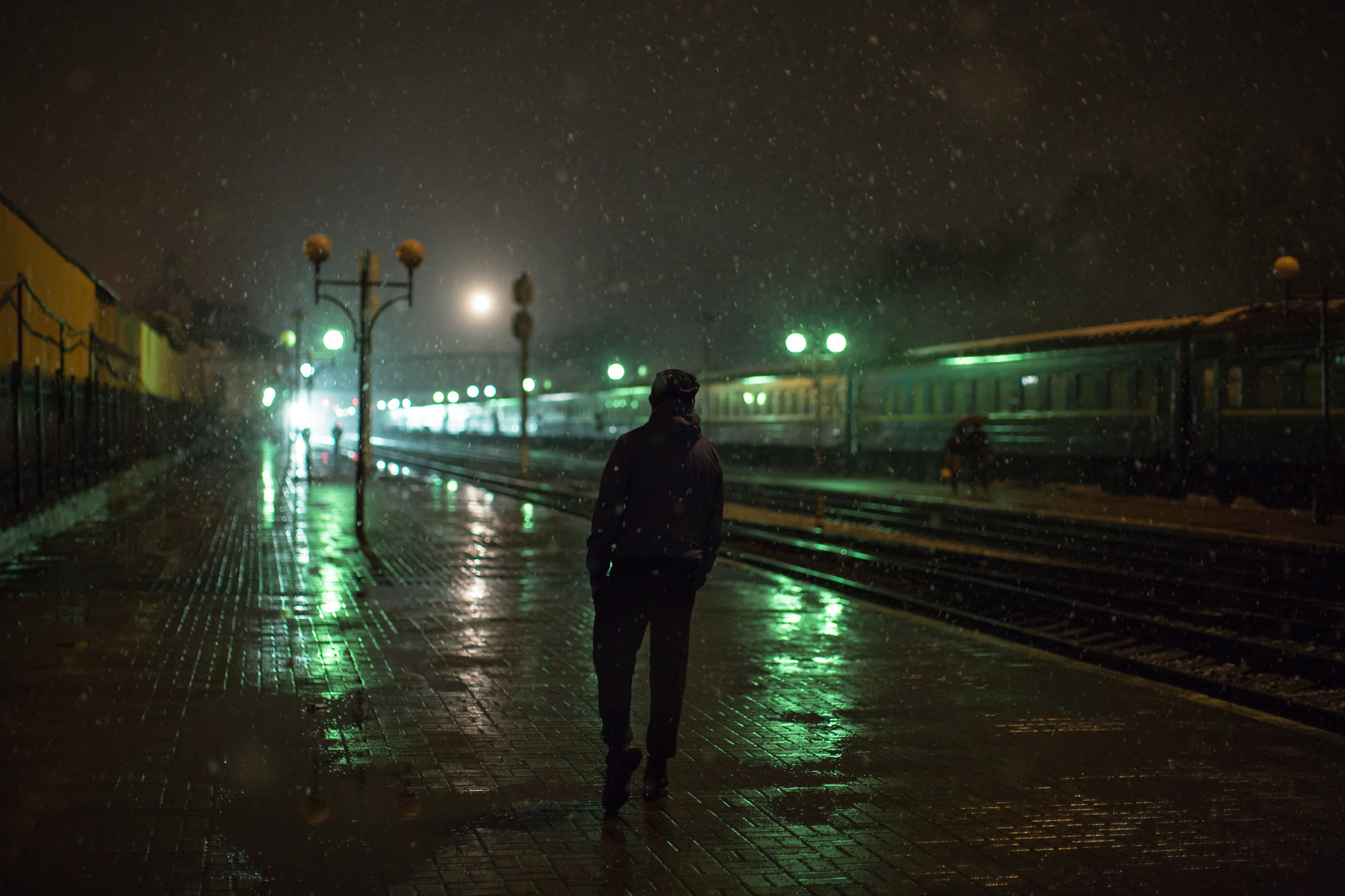 Man on a train station at night, a Person Photo by Andriy Photography