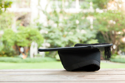 Graduation hat on vintage table with green nature background stock ...