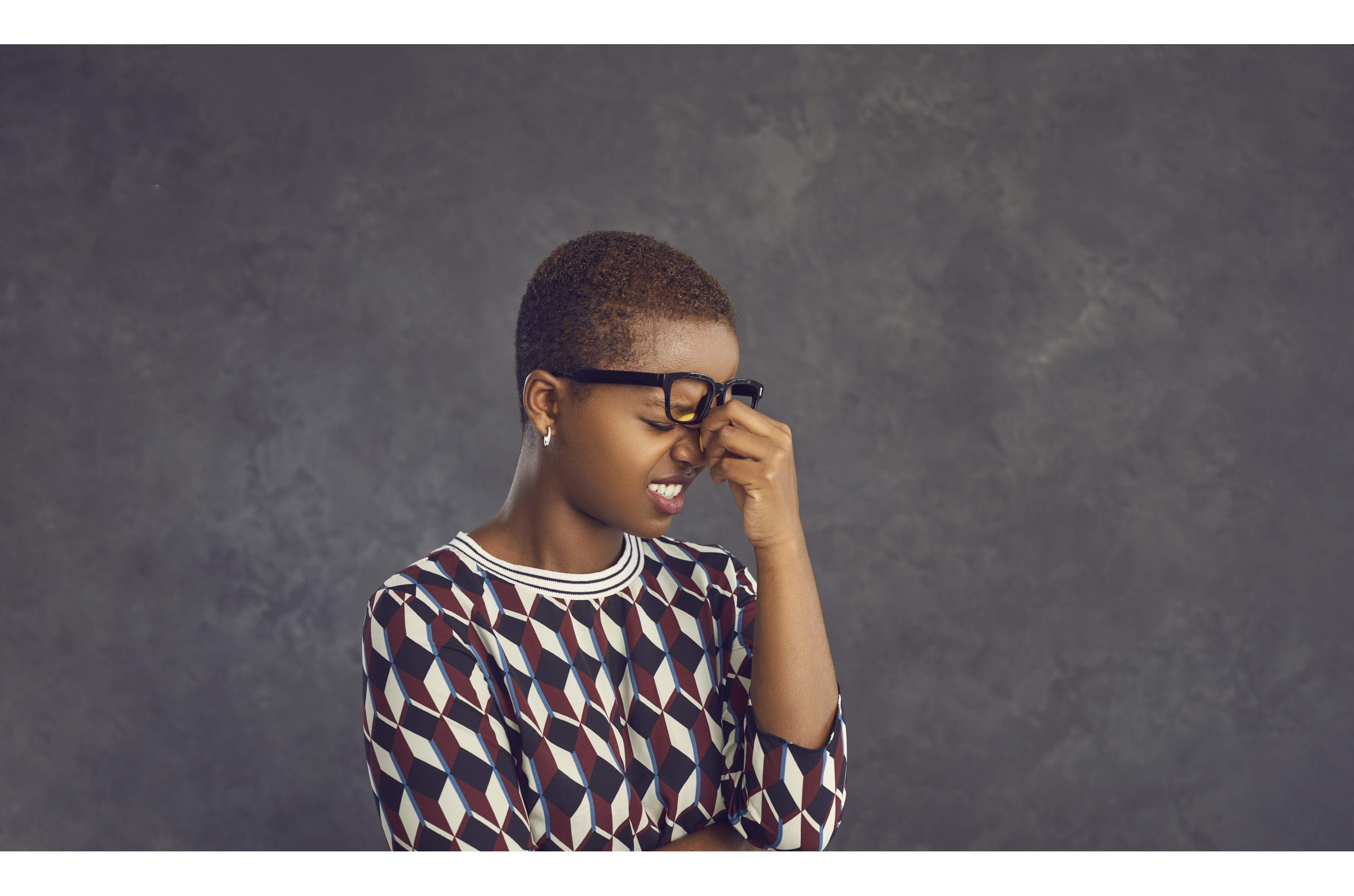 Stressed black woman cringing at | People Images ~ Creative Market