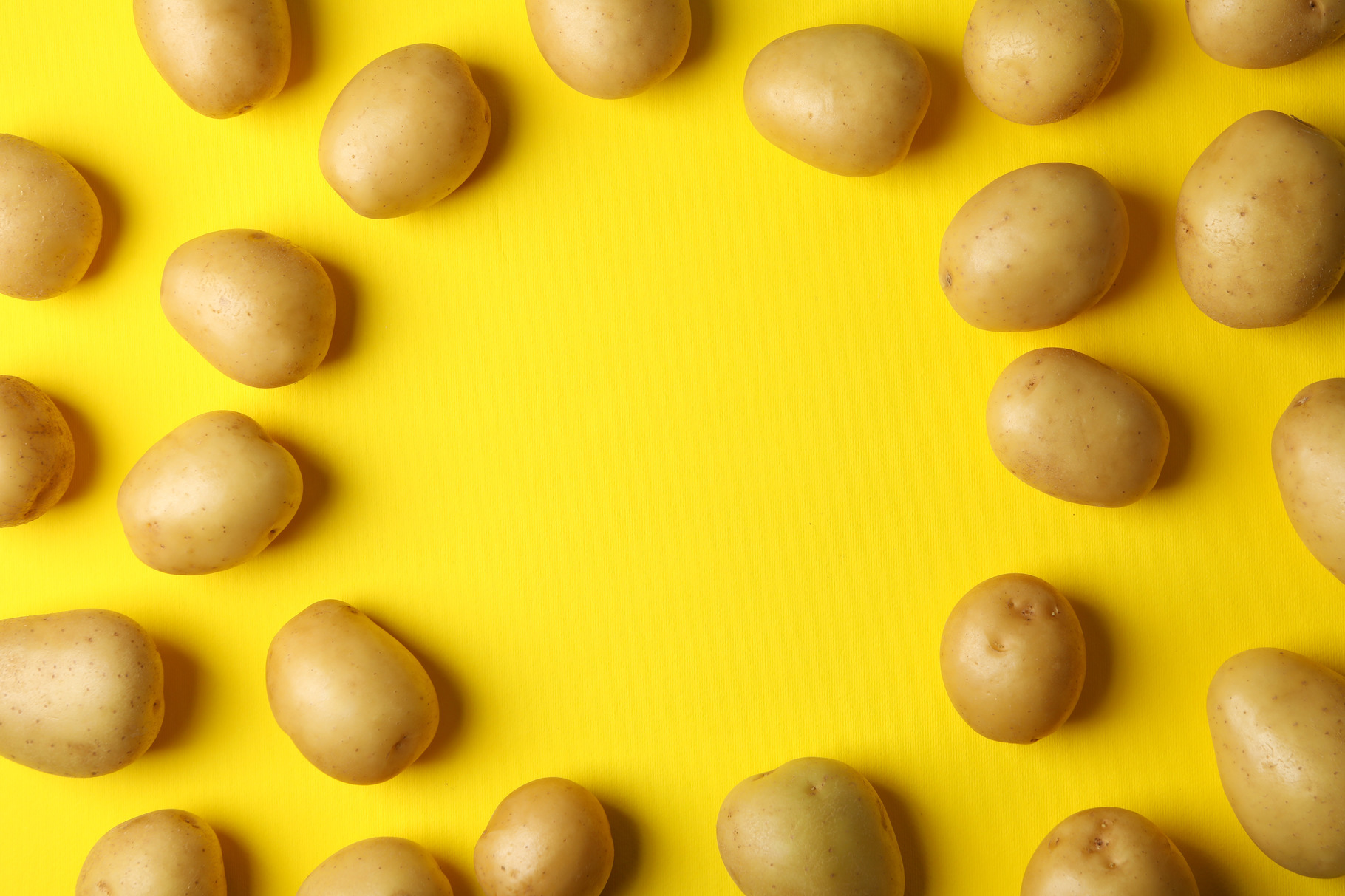 Young potato on yellow background, top view and space for text, a Food ...